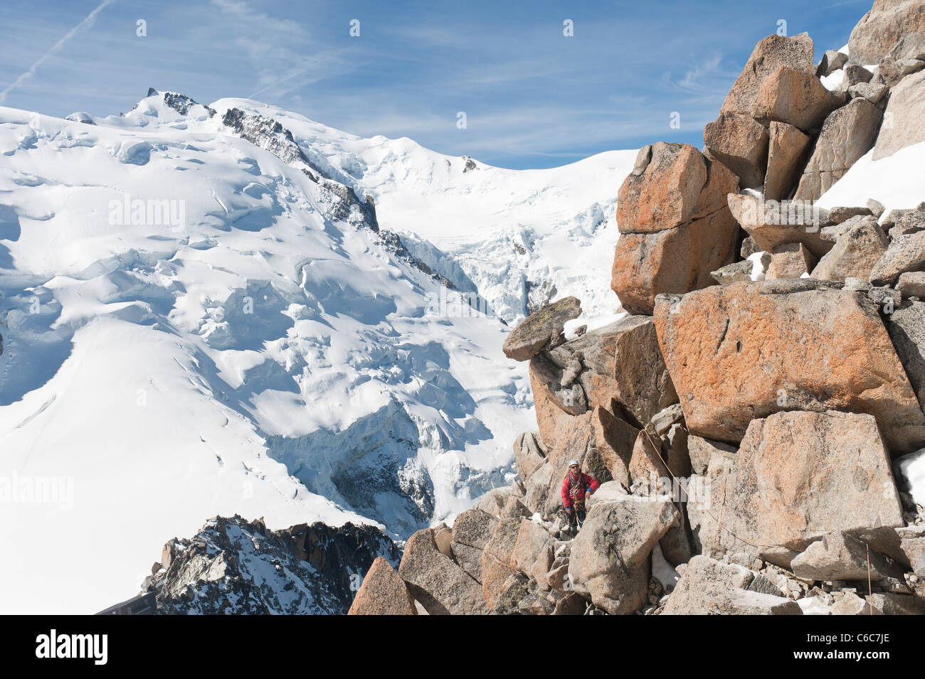 A male mountaineer climbing the Cosmiques ridge in Chamonix, France ...