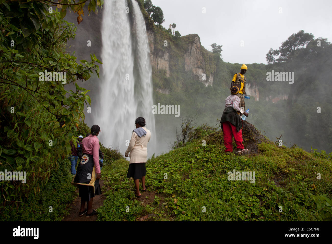 People admiring the view at a waterfall, Mount Elgon close to Sipi ...