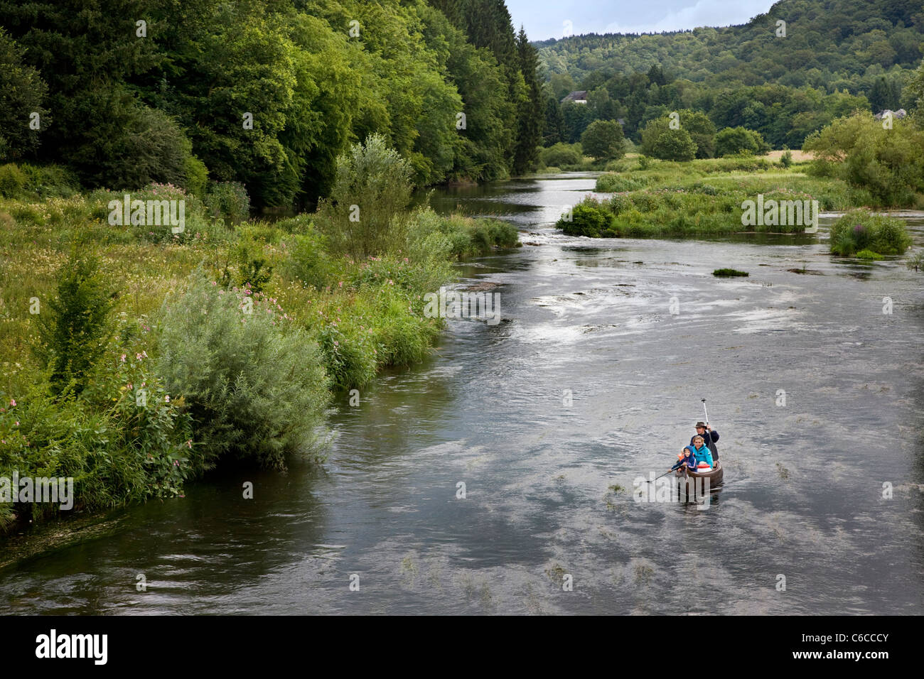 Tourists paddling in canoe on the river Semois in the Belgian Ardennes ...