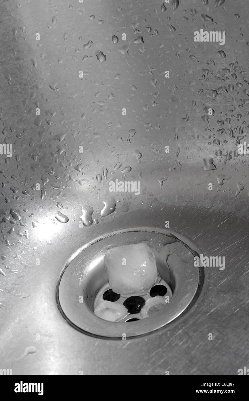 Metallic Kitchen sink with melting ice and water drops Stock Photo - Alamy