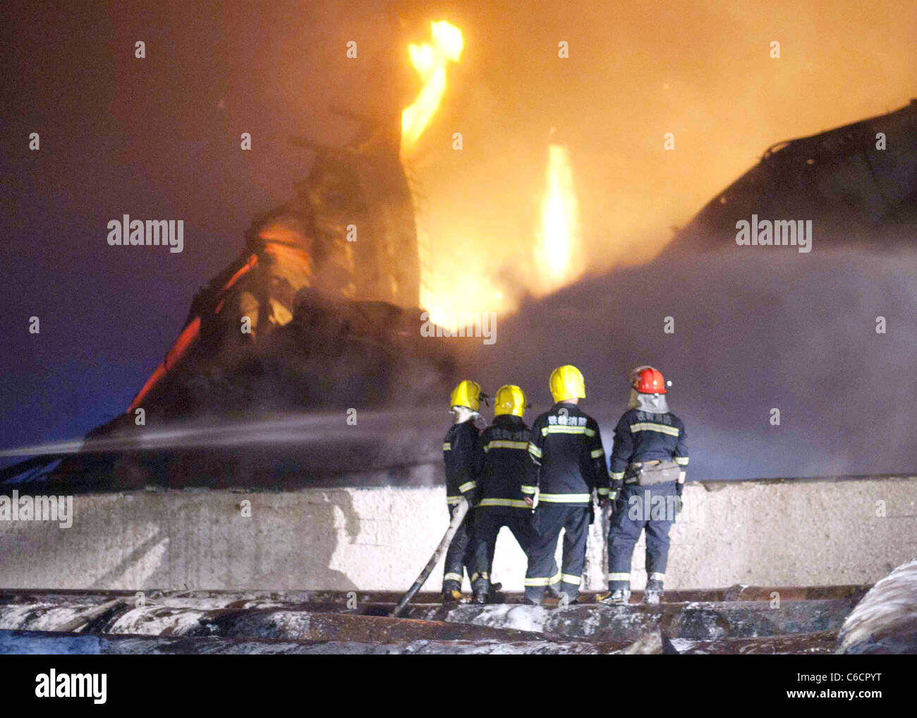 Firefighters try to put out the remaining fire after blasts hit two oil ...