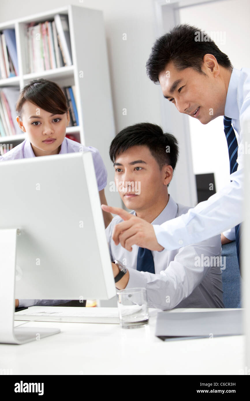 Businessmen working in front of a computer Stock Photo - Alamy