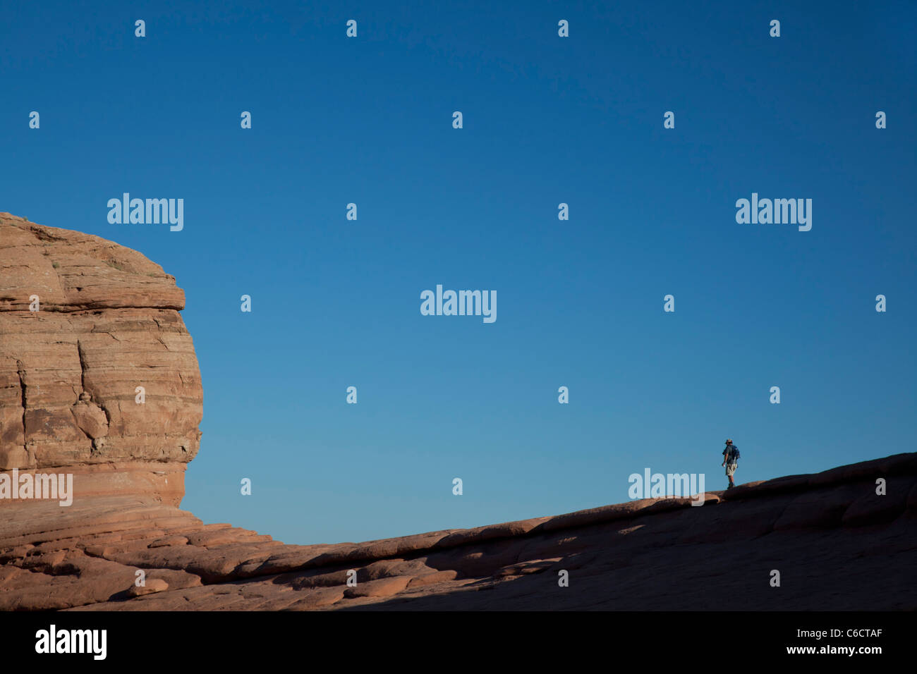 Moab, Utah - A man hikes on a ridge near Delicate Arch in Arches ...