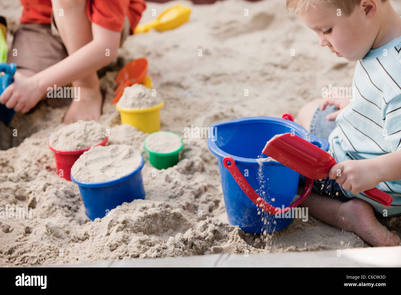 Caucasian brothers playing in sandbox Stock Photo - Alamy
