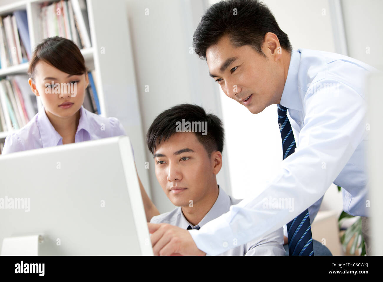 Businessmen working in front of a computer Stock Photo - Alamy