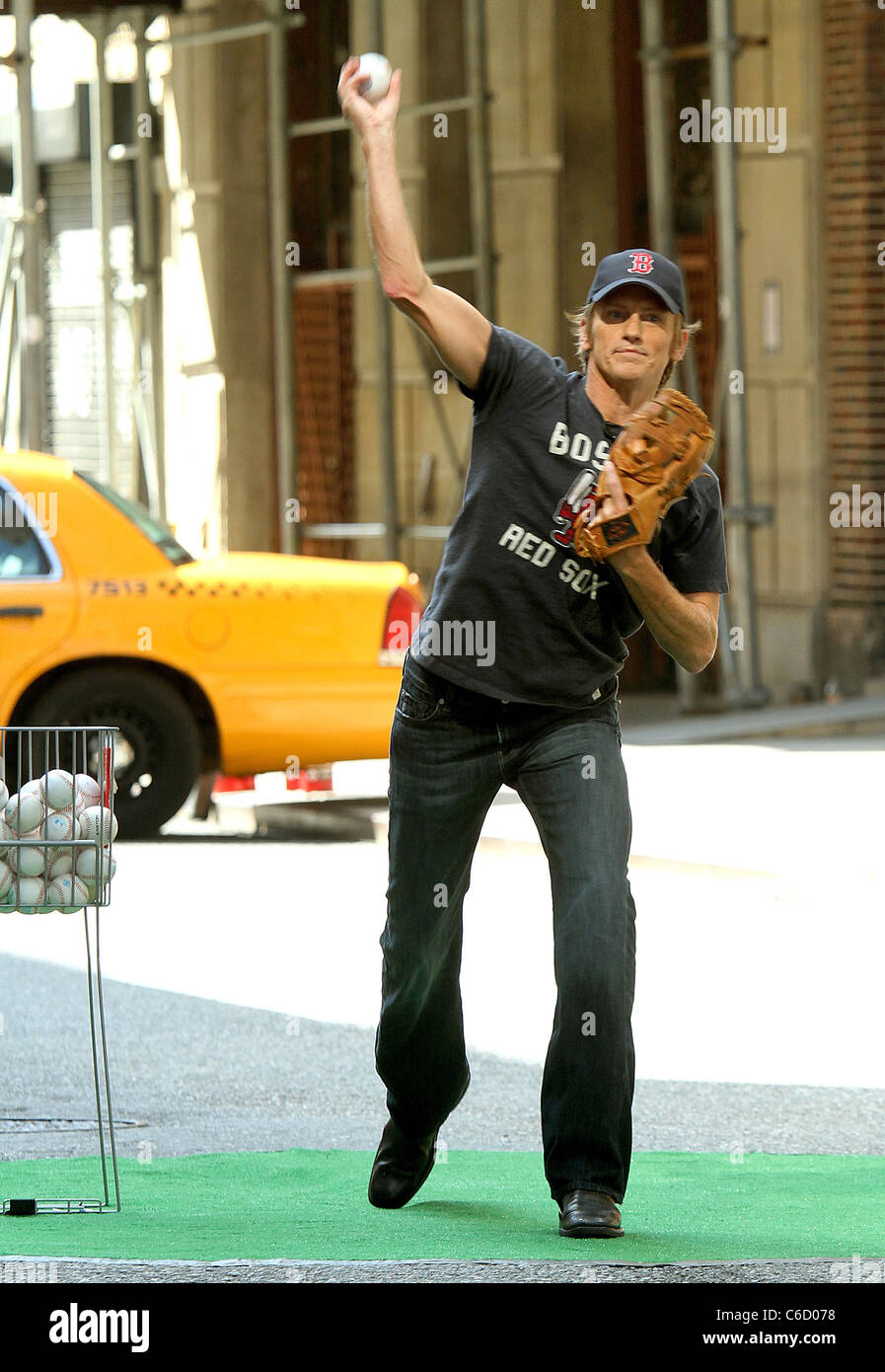 Actor Denis Leary has his Boston Red Soxs shirt and cap on to pitch to ...