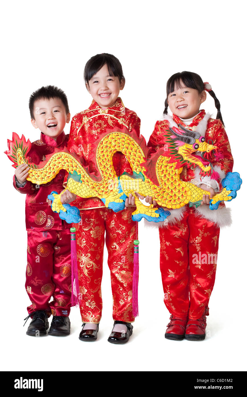 Three Chinese children holding Chinese dragon Stock Photo - Alamy