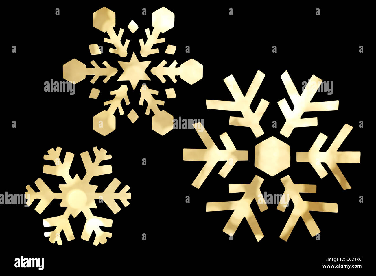 Golden snowflake isolated on black background Stock Photo - Alamy