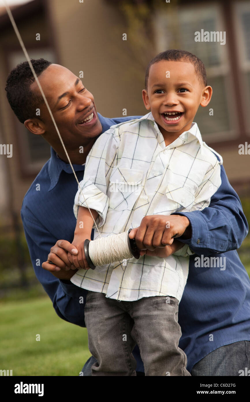 Father and son flying kite Stock Photo - Alamy
