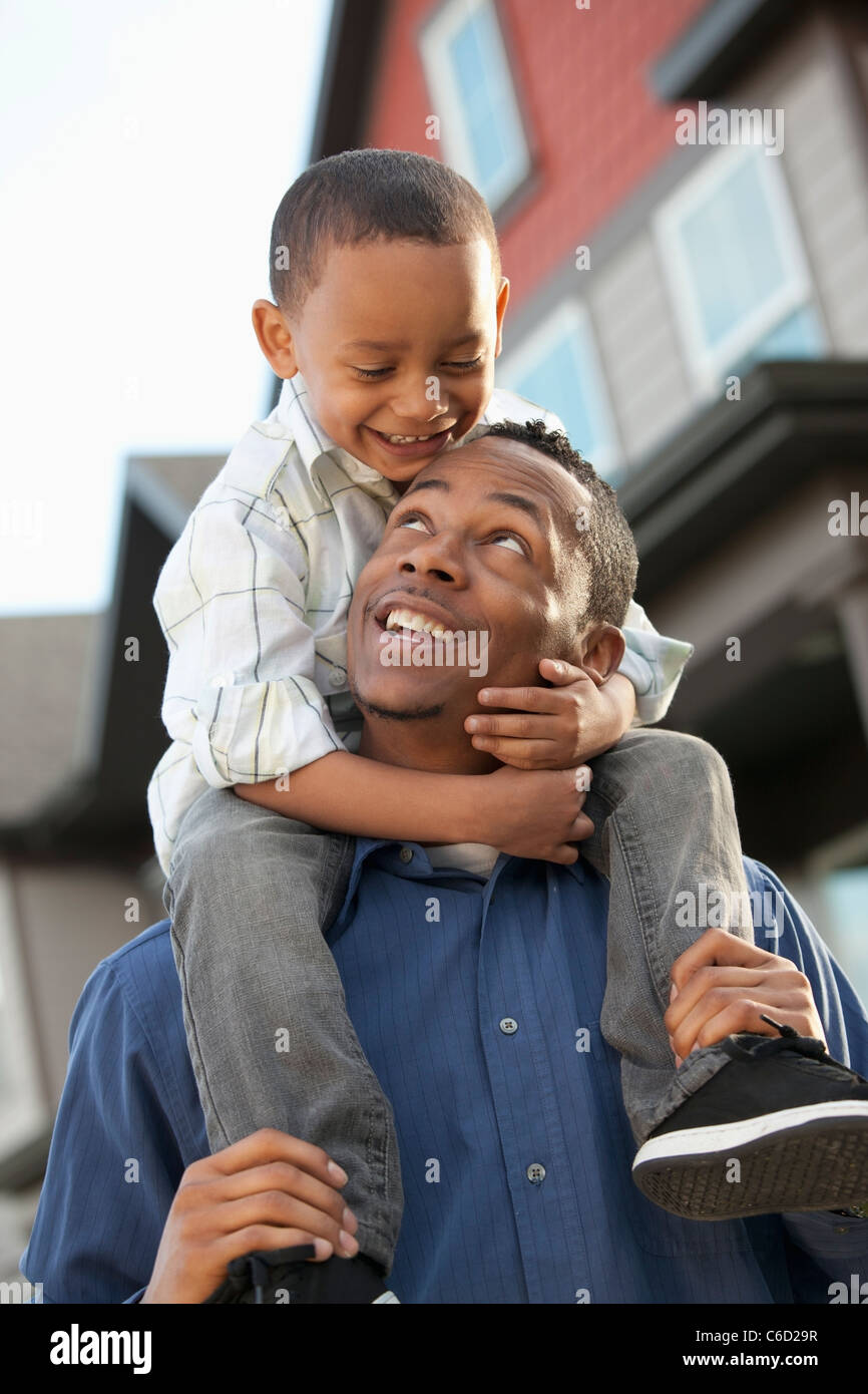 Father carrying son on shoulders Stock Photo - Alamy
