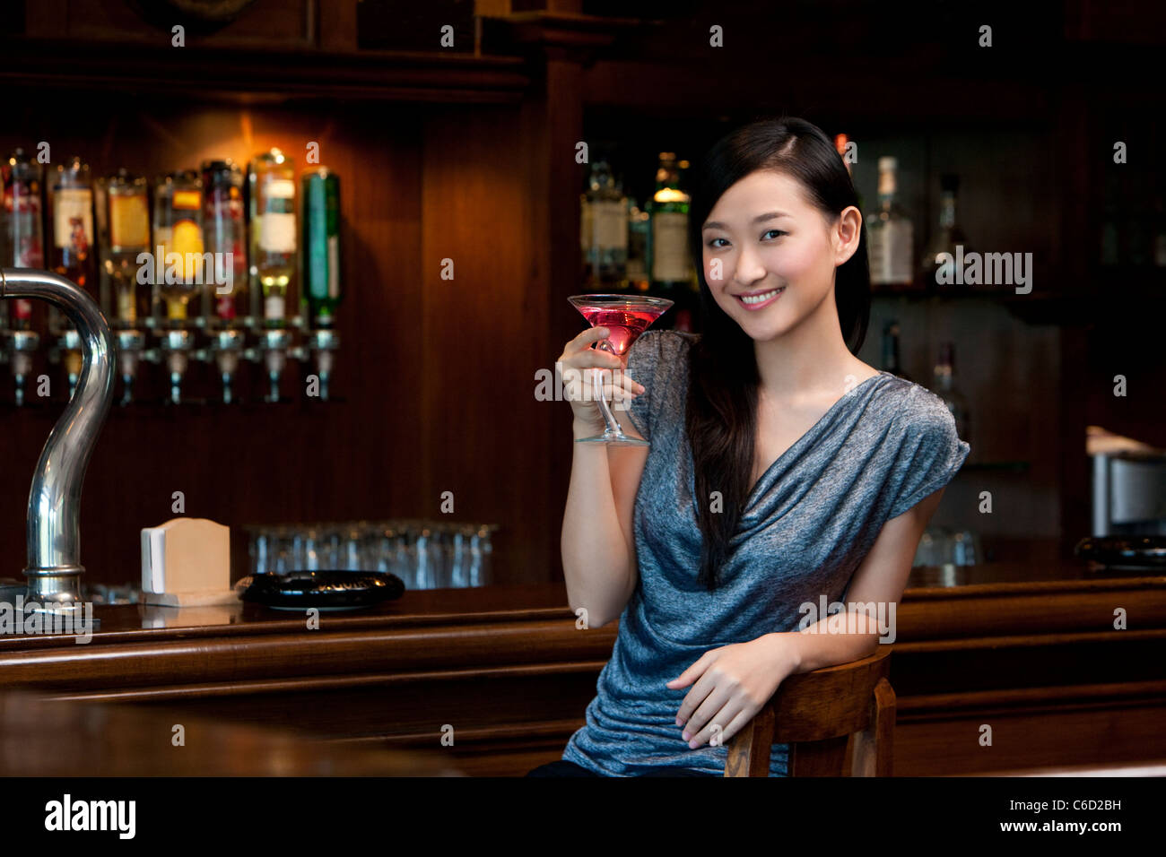 A Woman Relaxing at a Bar Stock Photo - Alamy