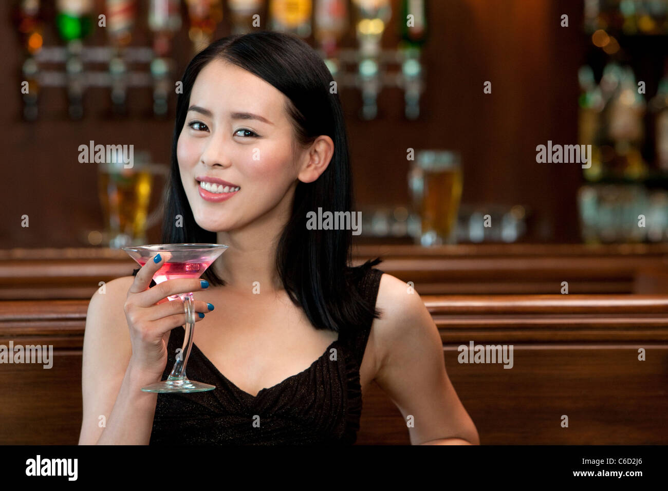 A Woman Relaxing at a Bar Stock Photo - Alamy
