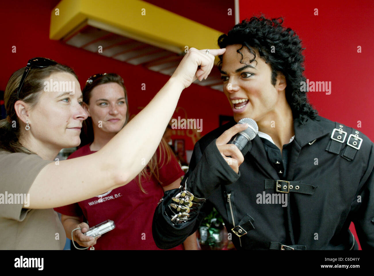 Fan touching Michael Jackson's wax figure Madame Tussauds in Washington ...