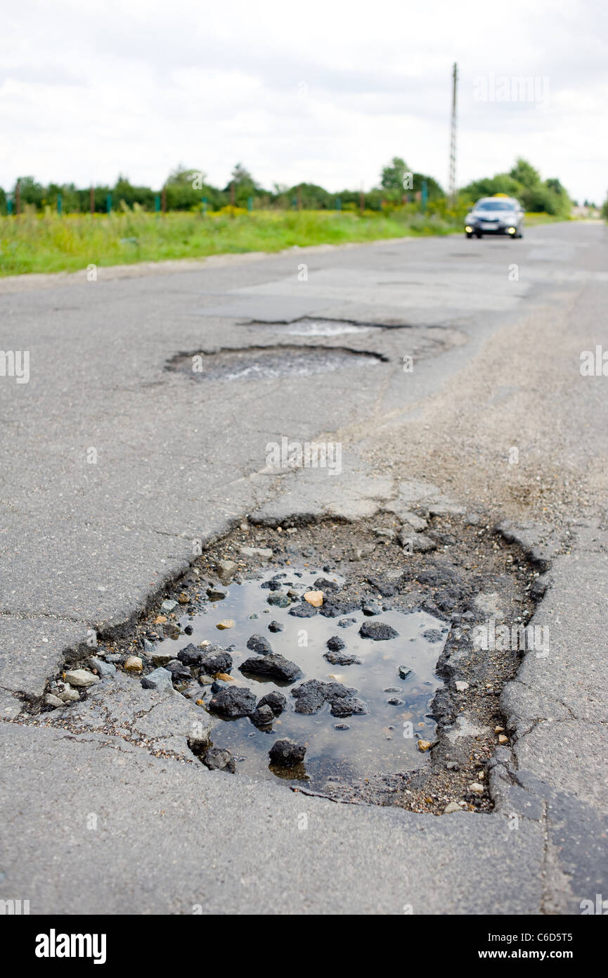 Puddle and rubbles in chuckhole Stock Photo - Alamy