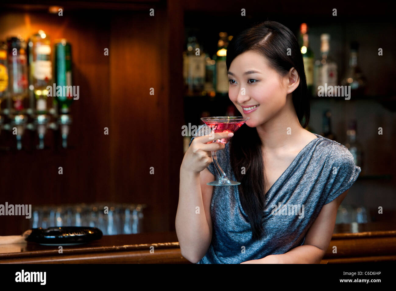 A Woman Relaxing at a Bar Stock Photo - Alamy