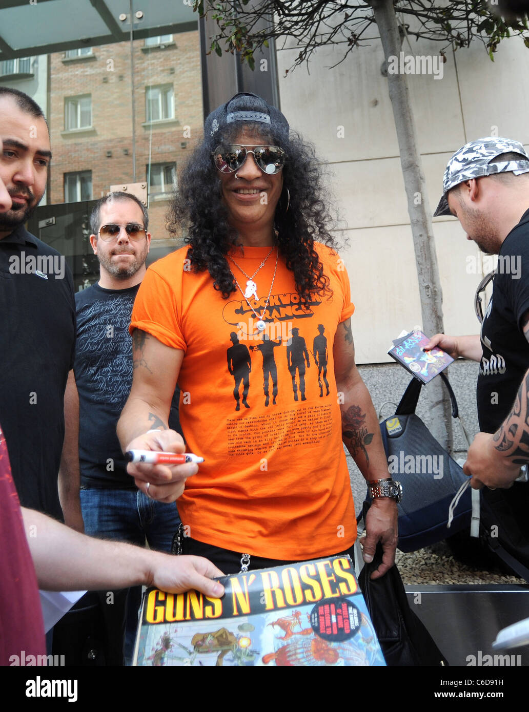 Former Guns N' Roses guitarist Slash signs autographs for fans as he ...