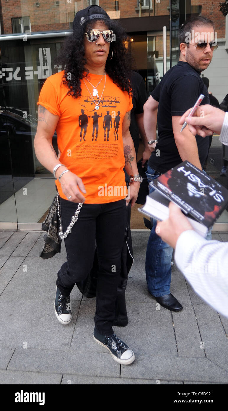 Former Guns N' Roses guitarist Slash signs autographs for fans as he ...