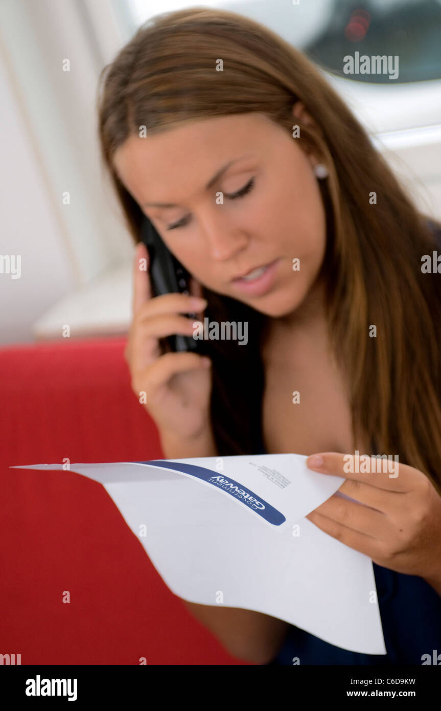 Young woman filling in tax forms Stock Photo - Alamy