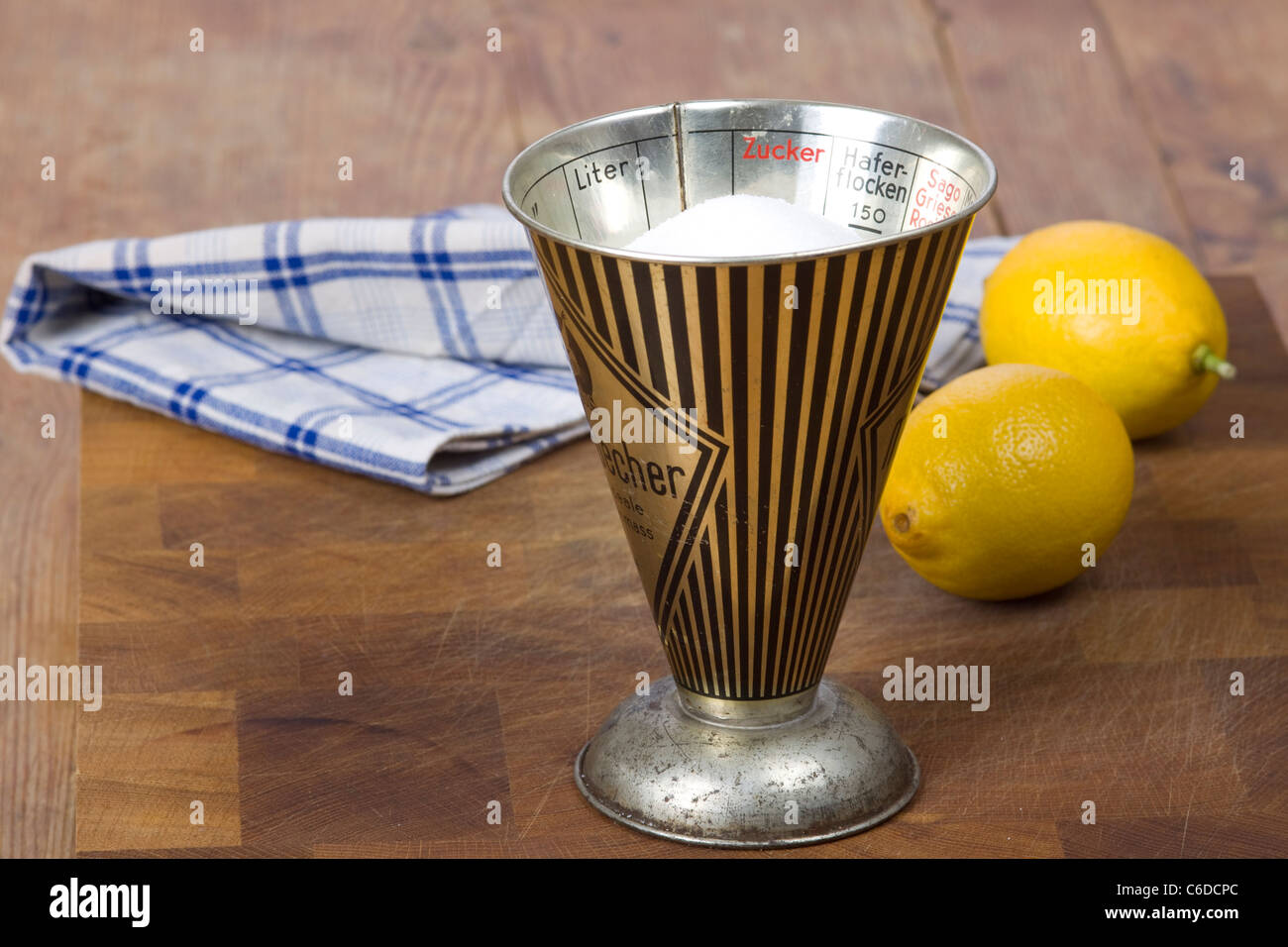 old conical measuring cup with lemons Stock Photo - Alamy