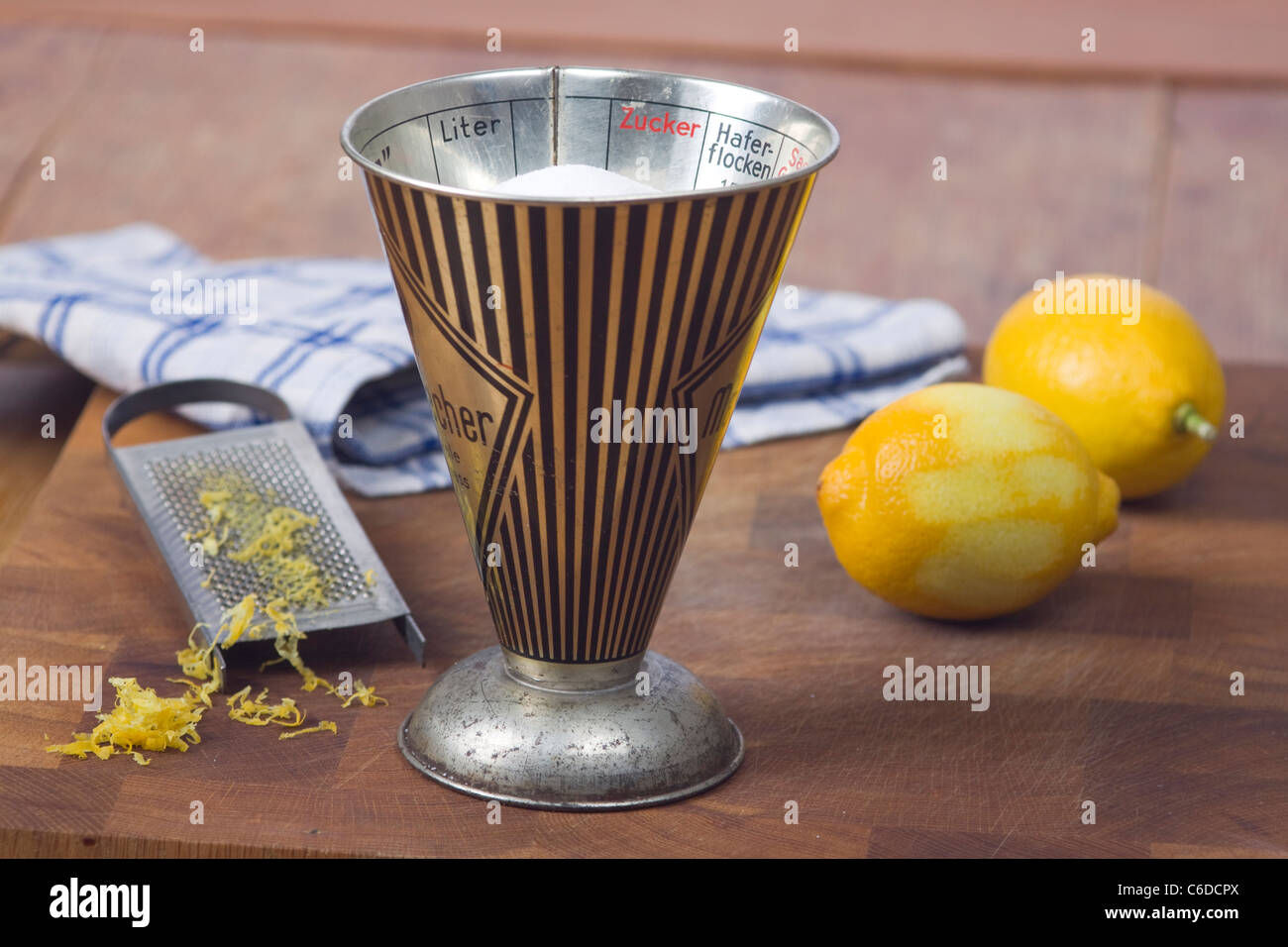 old conical measuring cup with lemons Stock Photo - Alamy
