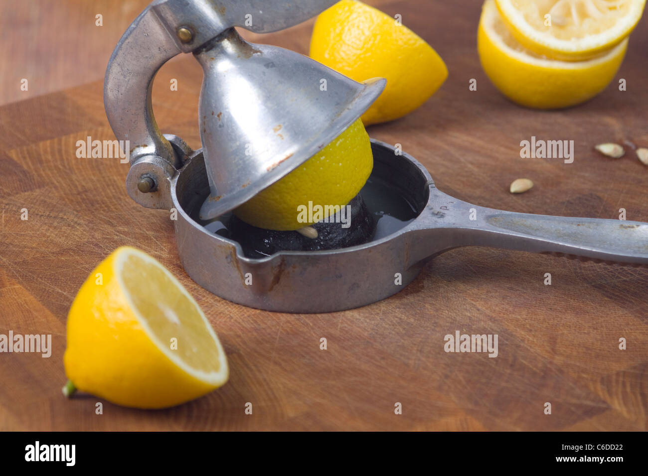 Old lemon squeezer with a lot of lemons Stock Photo - Alamy