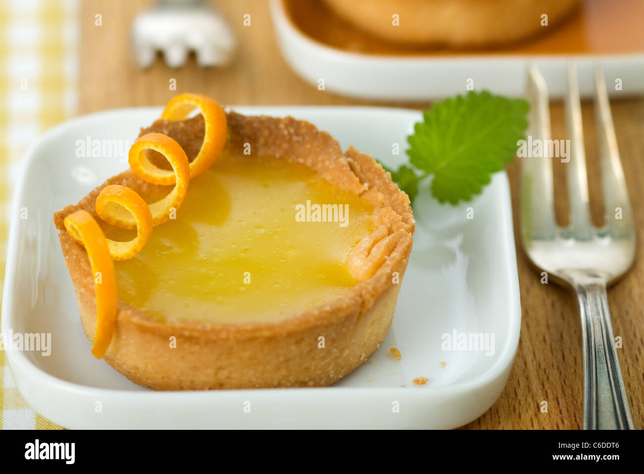 Two small orange tarts on small bowls Stock Photo - Alamy