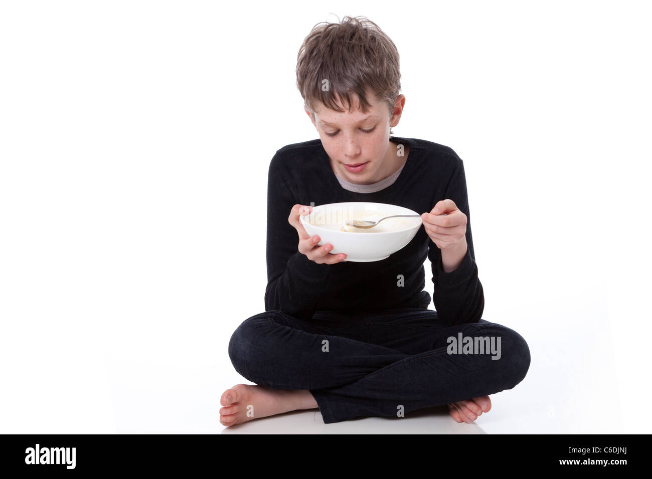 Boy eating from bowl Stock Photo - Alamy