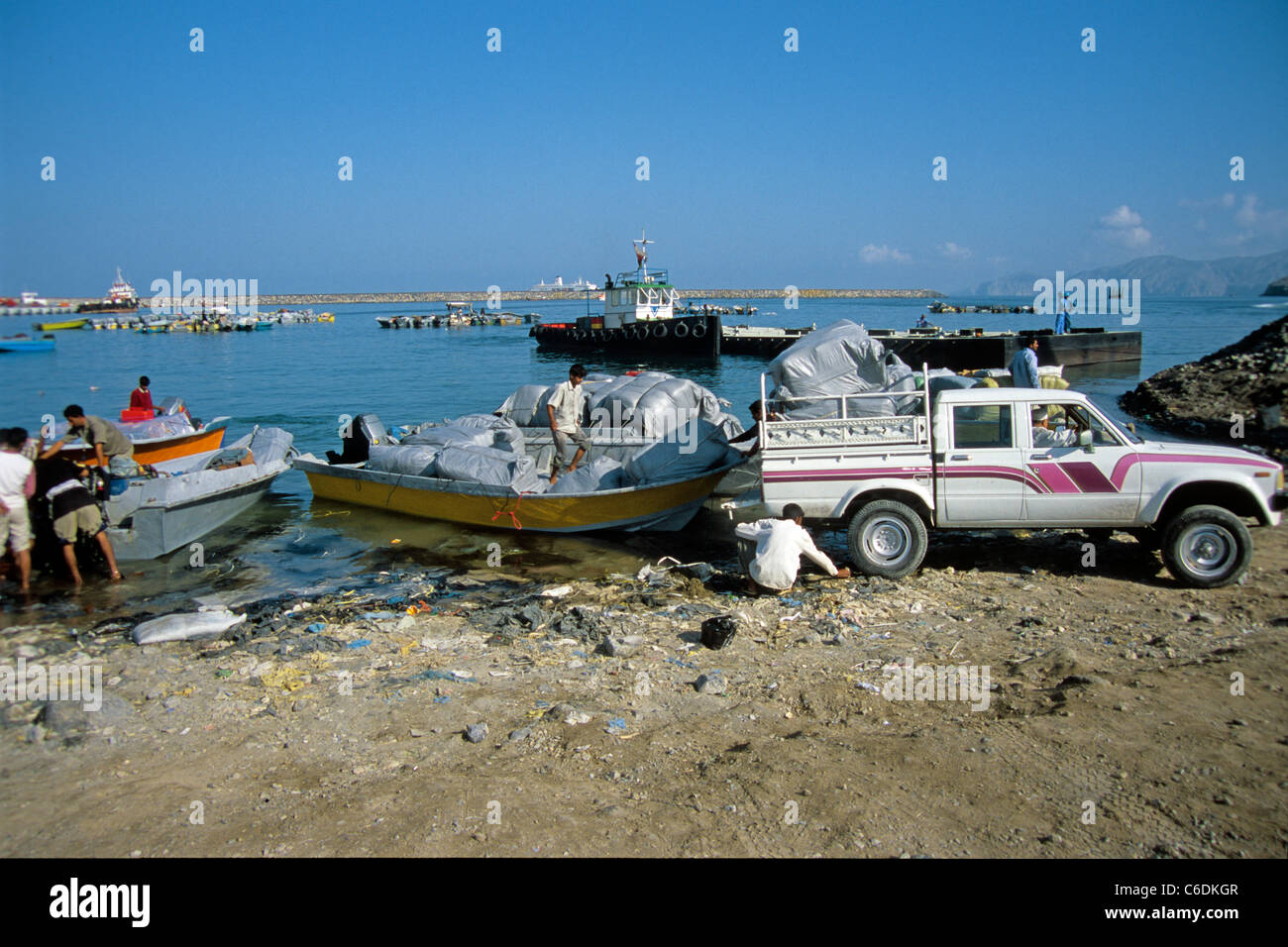 Smuggler from Iran loading goods to small but fast motor boats ...