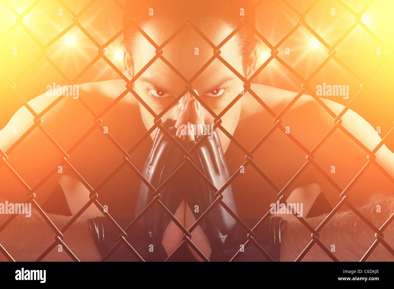Cage fighter concentrating , staring at the camera , dramatic lighting ...