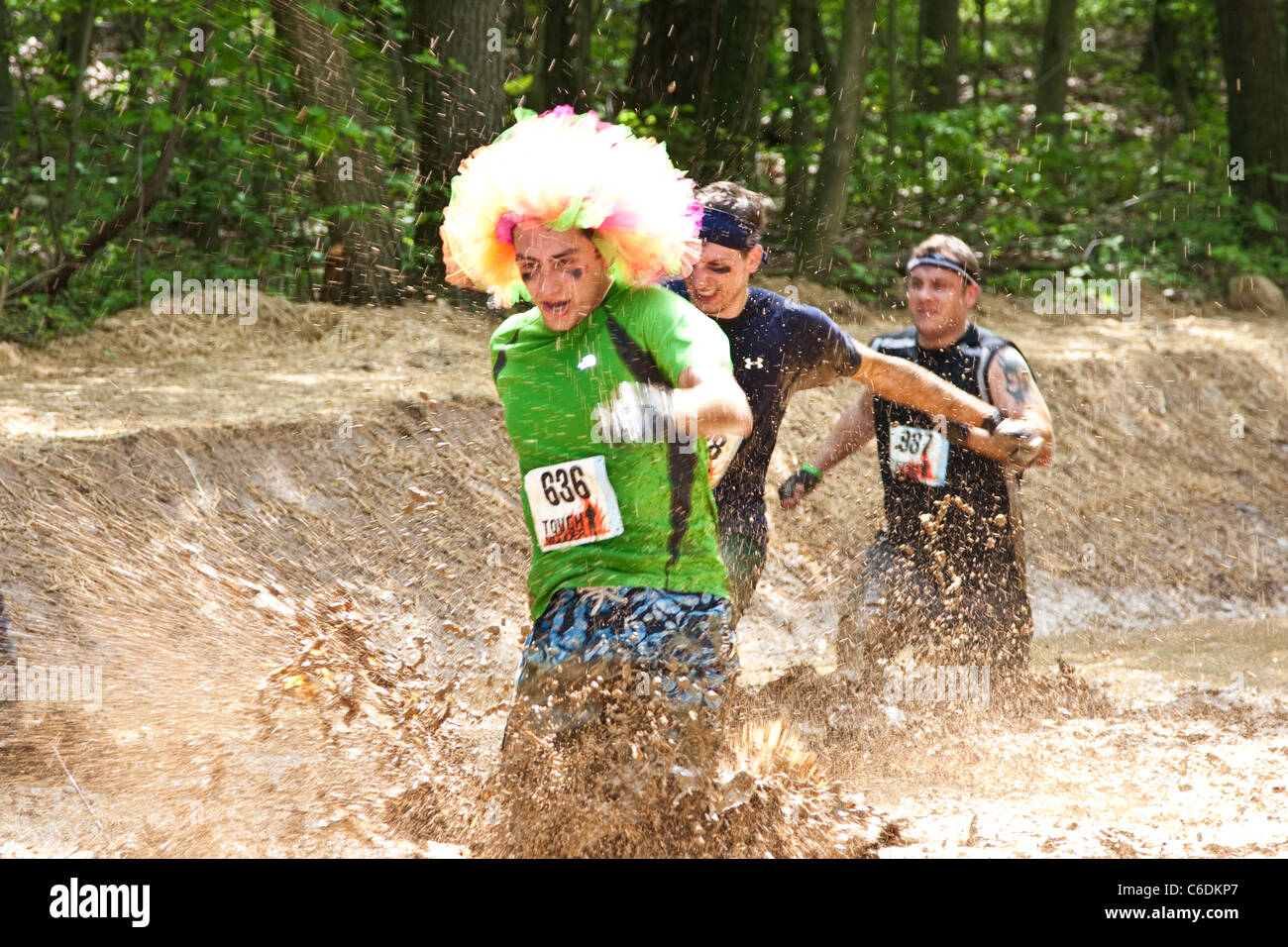 A Tough Mudder participant runs through the 'Swamp Stomp'' section of ...
