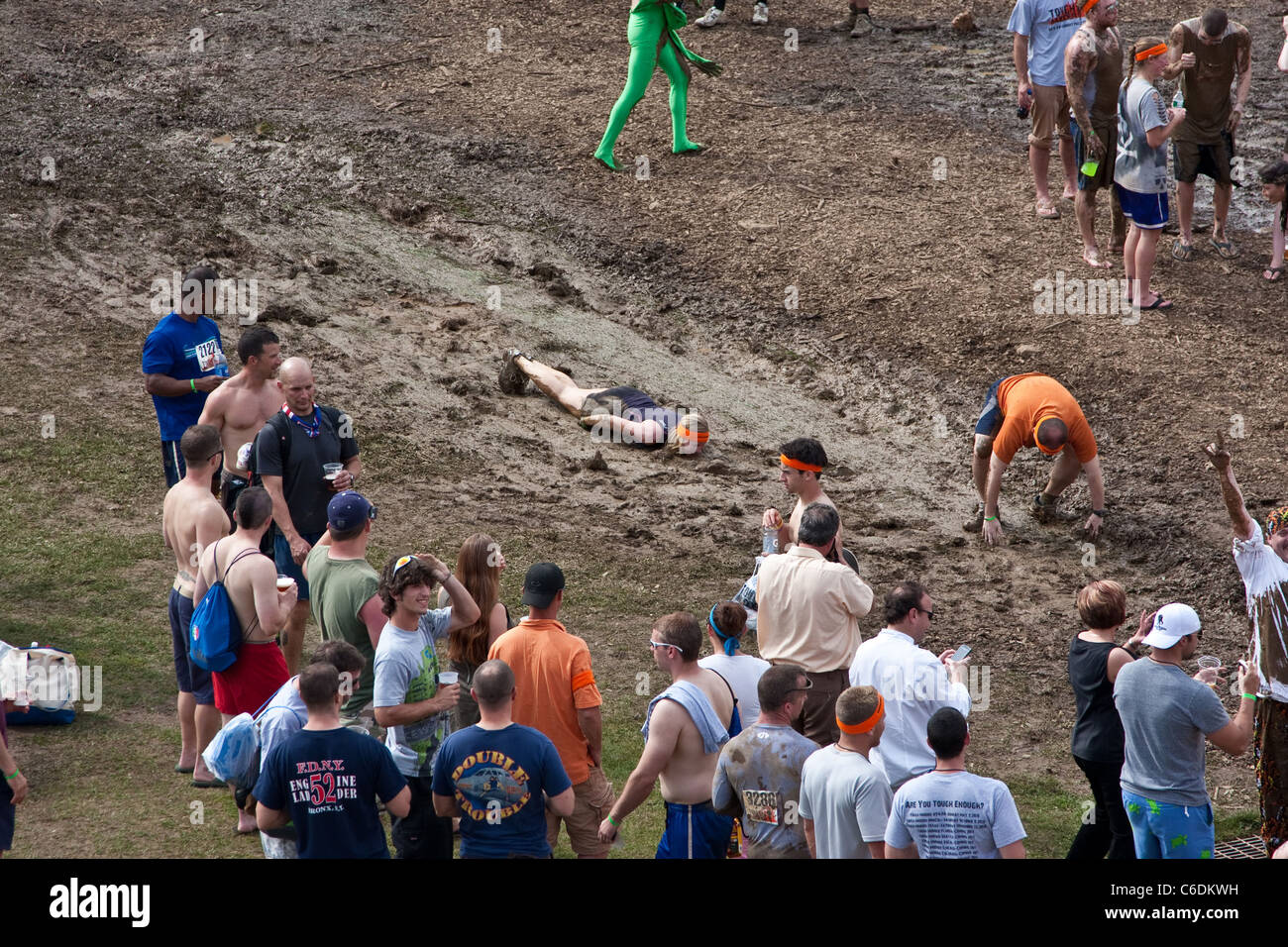 Tough Mudder participants slide in the mud at the post race after party ...