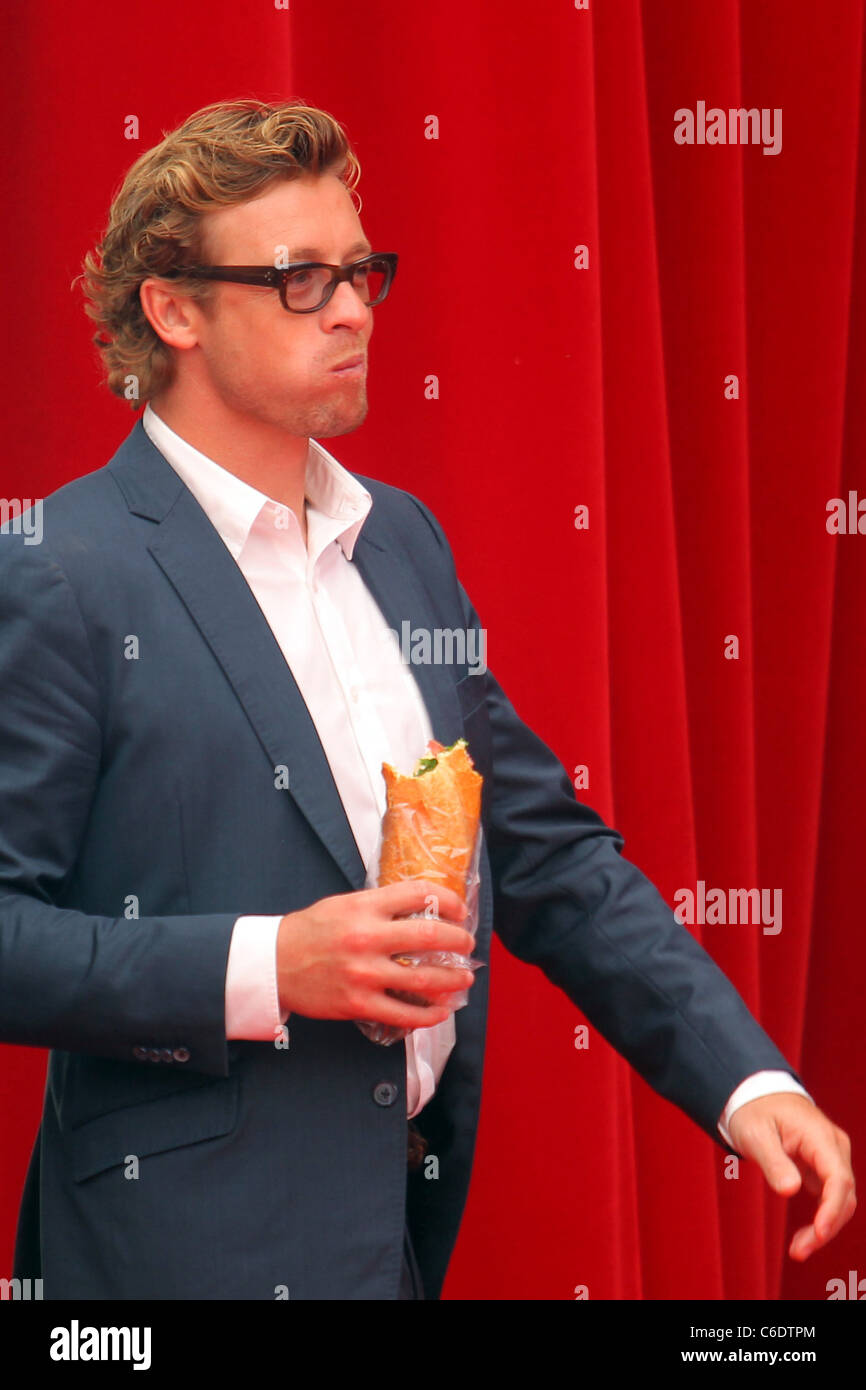 Simon Baker accepts a French sandwich from the press 50th anniversary ...