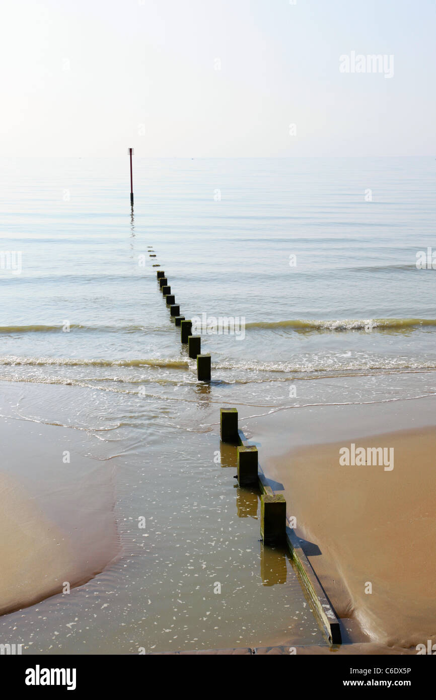 Half submerged groyne on Dymchurch beach Kent Stock Photo - Alamy