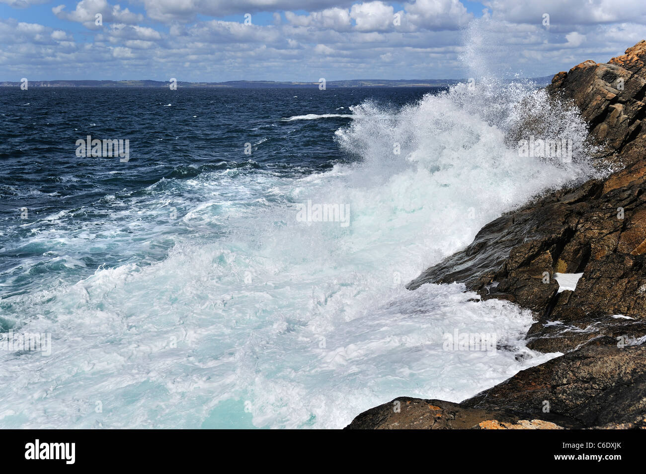 Waves crashing into rocks of cliff along the Brittany coast, France ...
