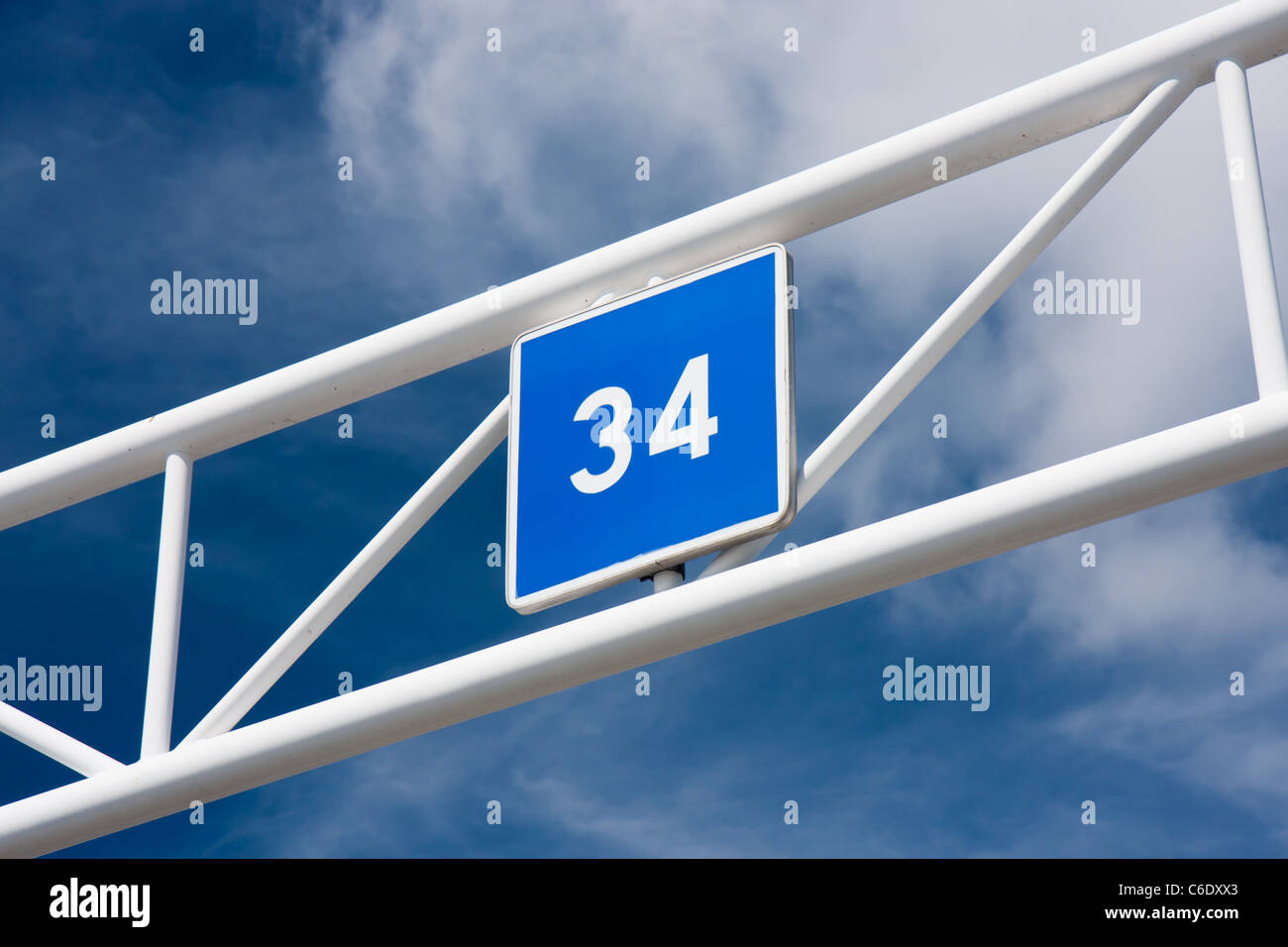 A blue sign showing the number 34 Stock Photo - Alamy