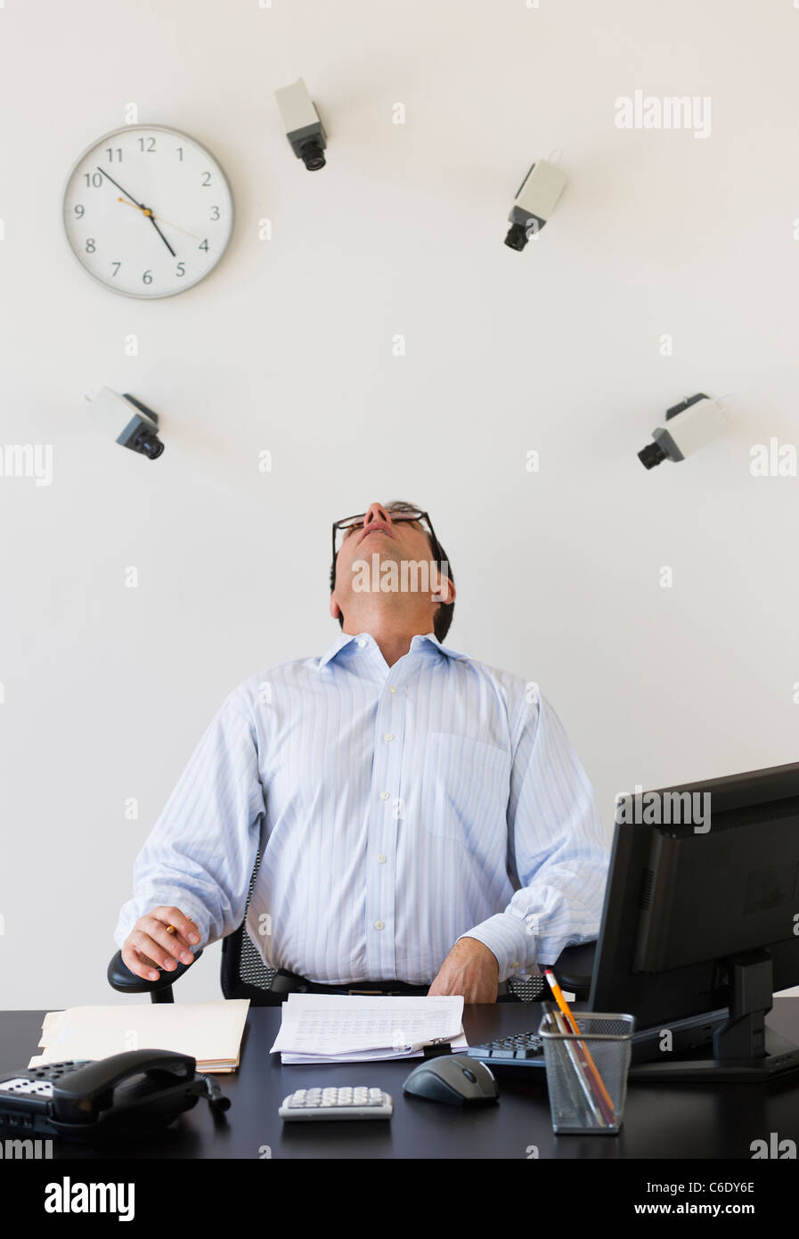 Security cameras watching office worker Stock Photo - Alamy