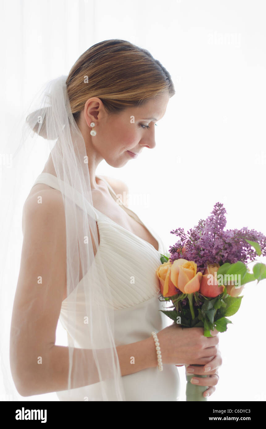 Bride holding floral bouquet Stock Photo - Alamy
