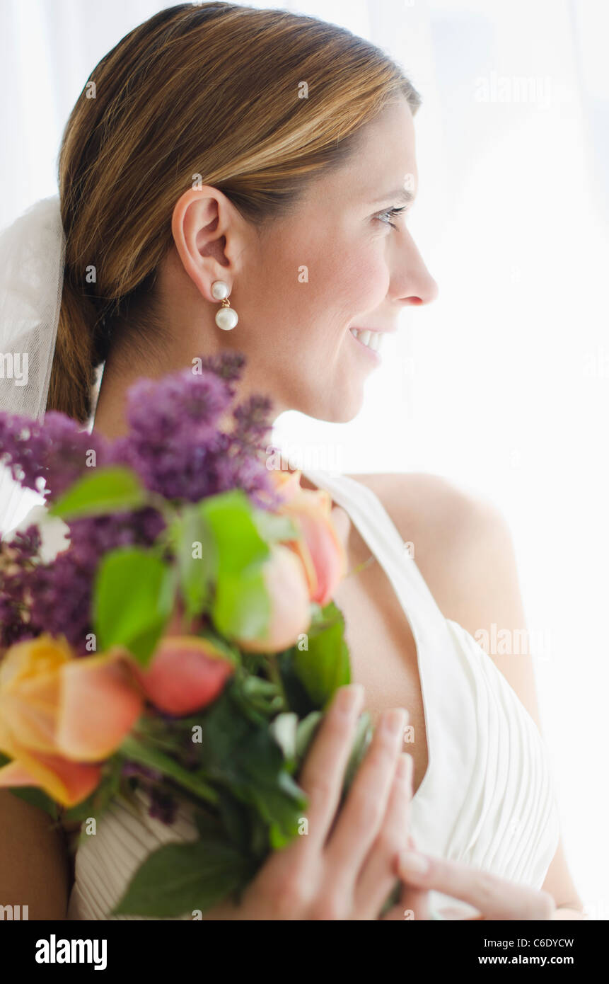 Bride holding floral bouquet Stock Photo - Alamy