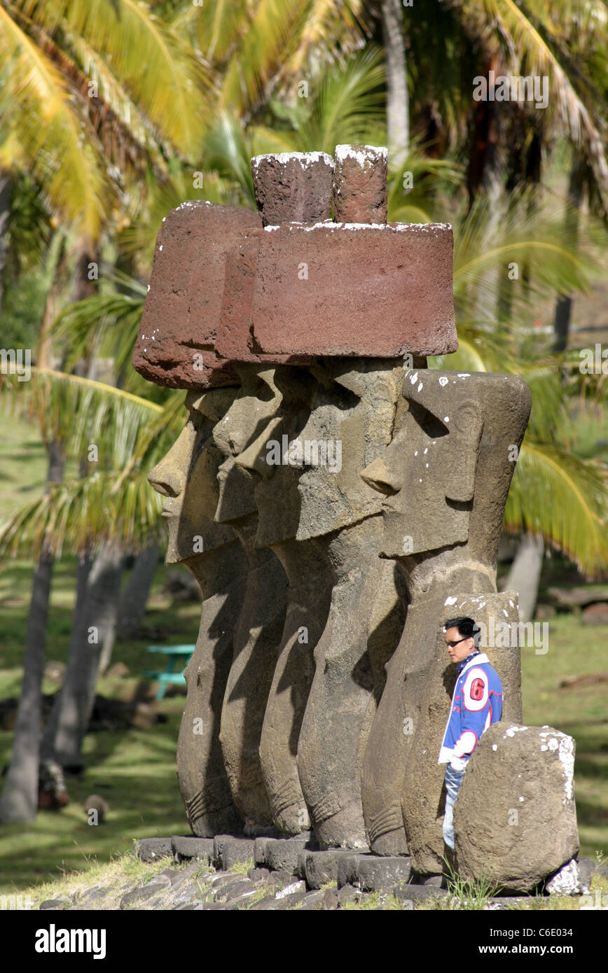 Tourist posing with Moai statues of Ahu Nau Nau at Anakena Beach on ...
