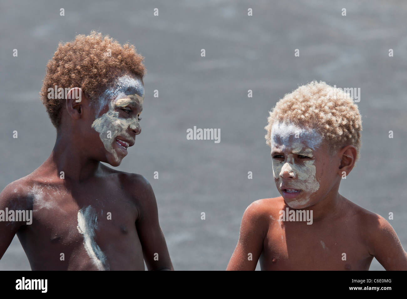 Local Children with Traditional face Paint Play near the Ash and Lava ...