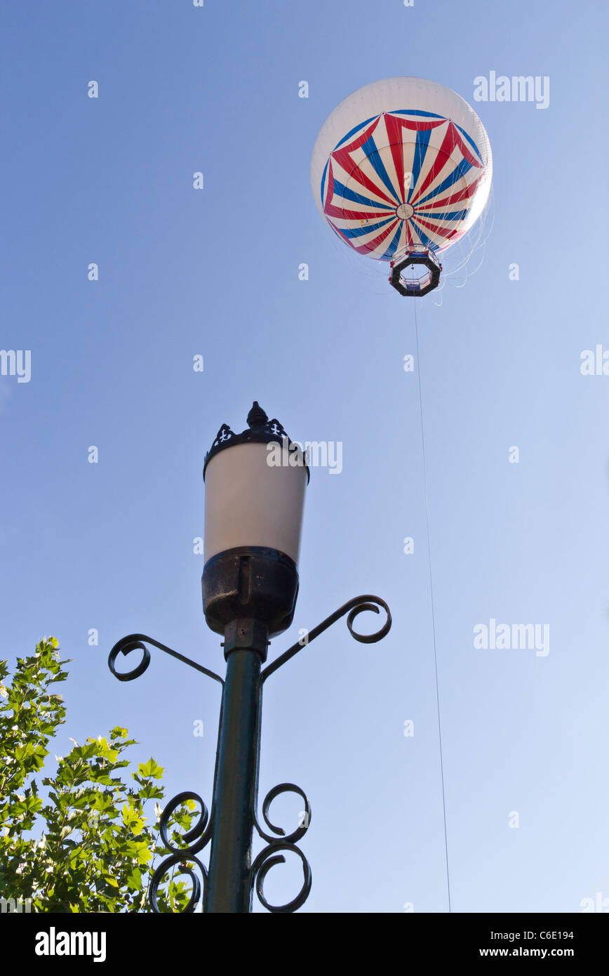 Floating helium observation balloon with blue sky, tethered seemingly ...