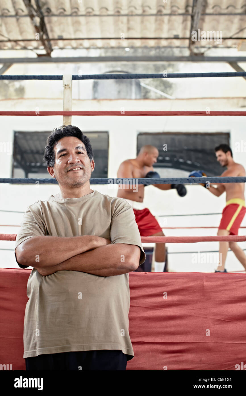 Hispanic trainer standing next to boxers fighting in ring Stock Photo ...