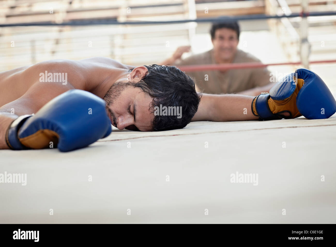 Knocked-out Hispanic boxer laying on ground Stock Photo - Alamy