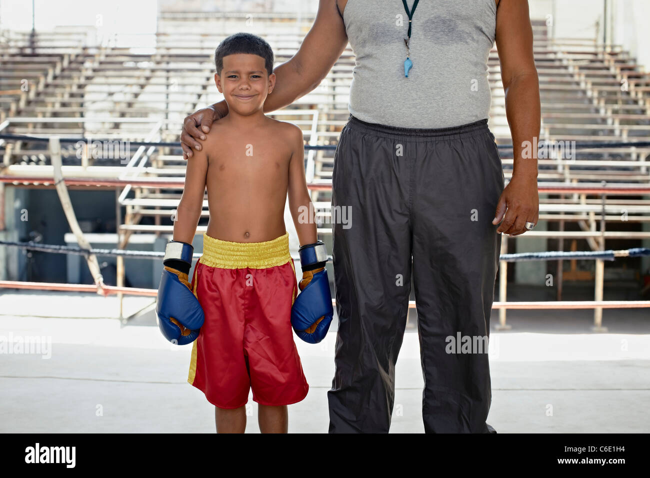 Hispanic trainer standing with boy in boxing gear Stock Photo - Alamy