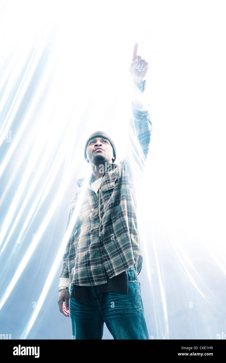 African American man pointing at light spark Stock Photo - Alamy
