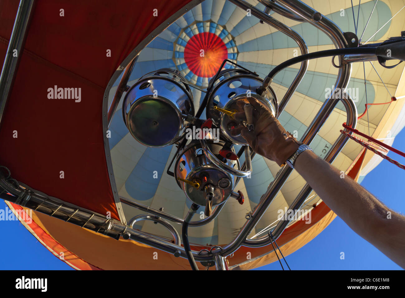 close up from a pilot operating the burners of a hot air balloon on ...