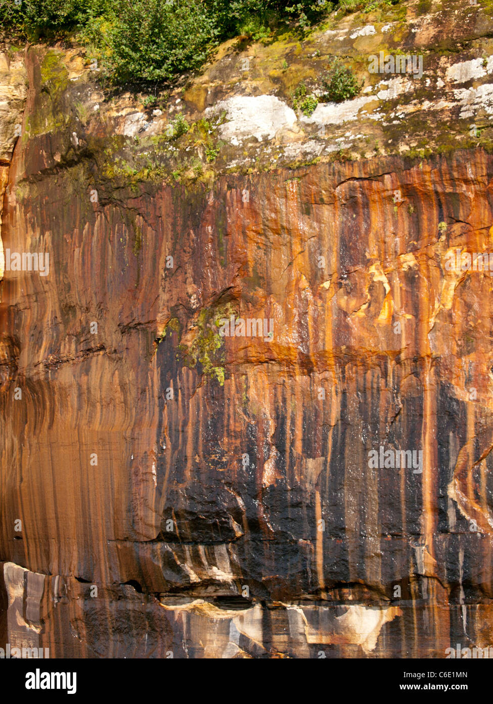 Michigan's Pictured Rocks has streaks on the face of the cliffs that ...