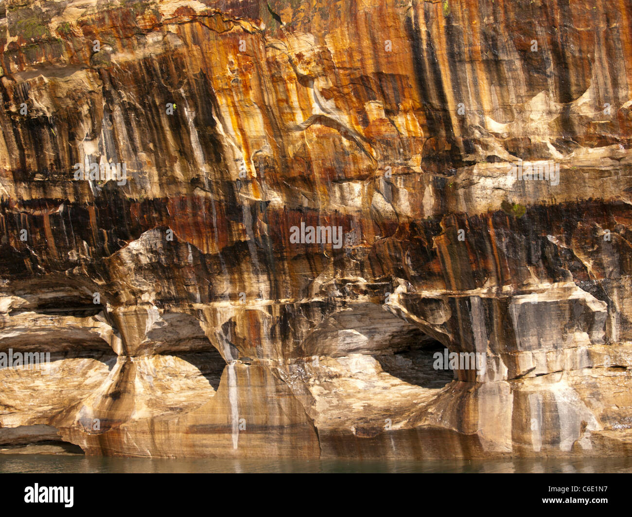 Michigan's Pictured Rocks has streaks on the face of the cliffs that ...
