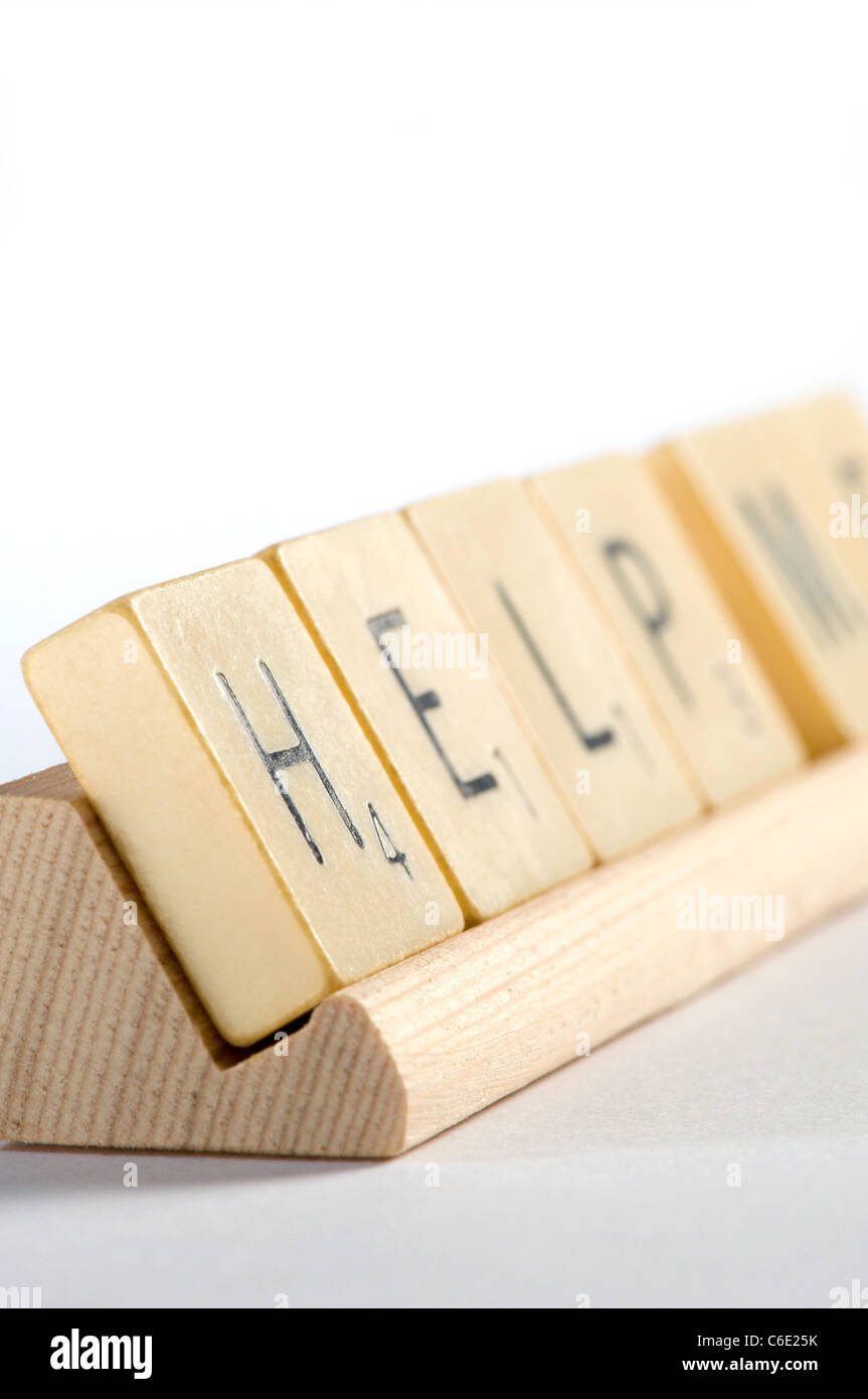 Help spelled with scrabble tiles Stock Photo - Alamy