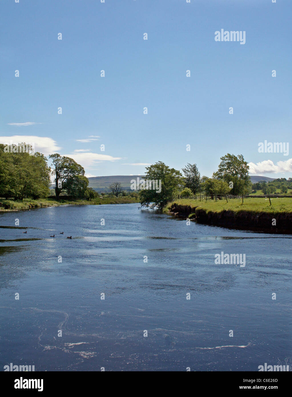 A lazy river winds its way through a lush green valley in Yorkshire ...